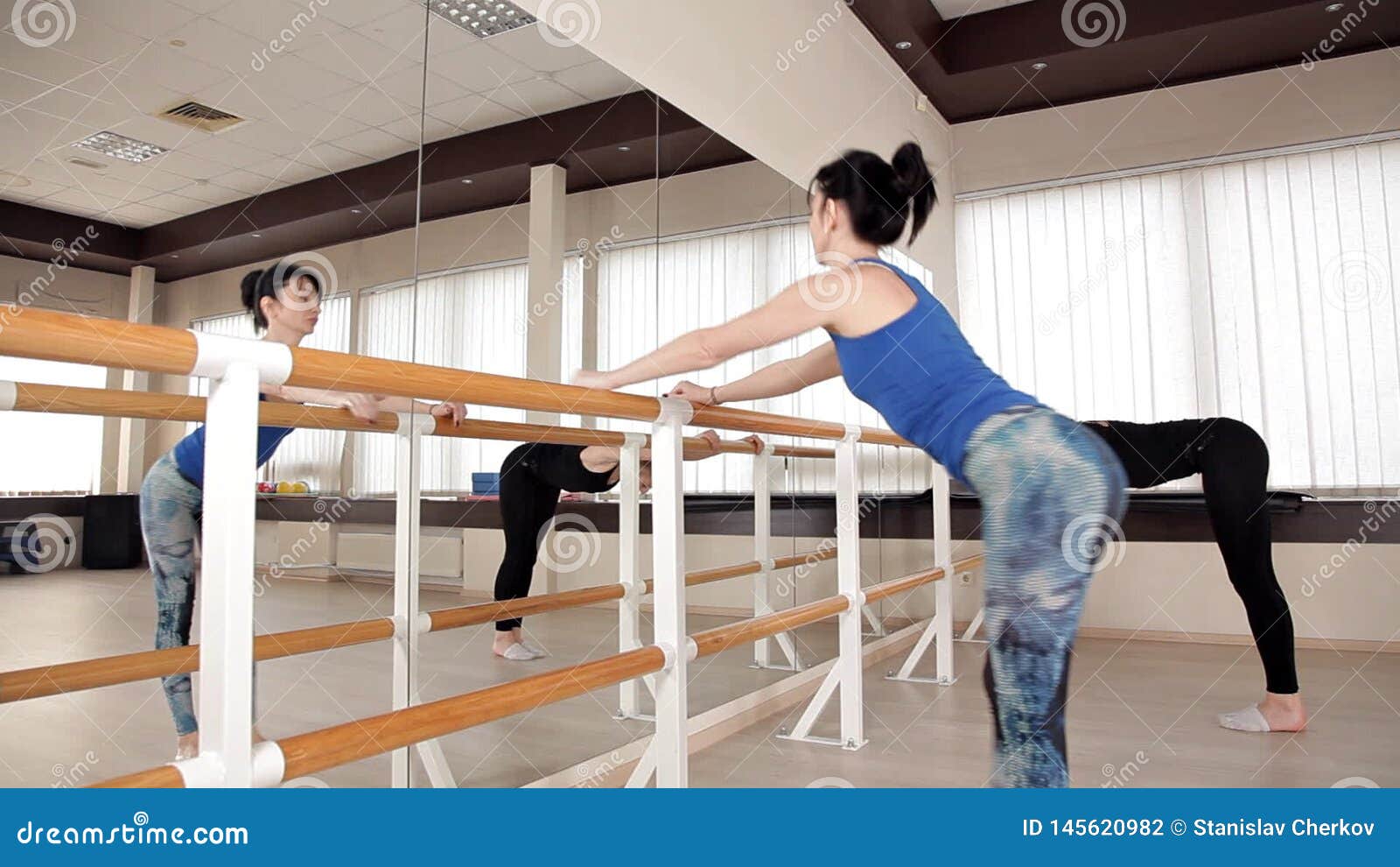 Two Girls in the Ballet Studio Train at the Bench and Mirror ...