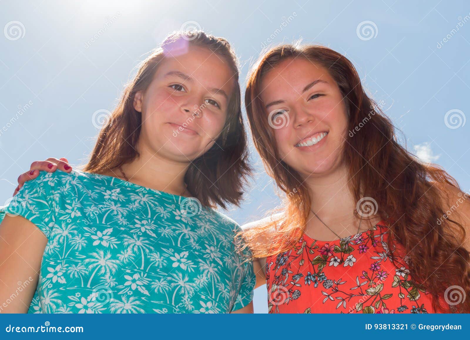 Two Girls with Blue Sky and Sunlight in the Background Stock Image ...
