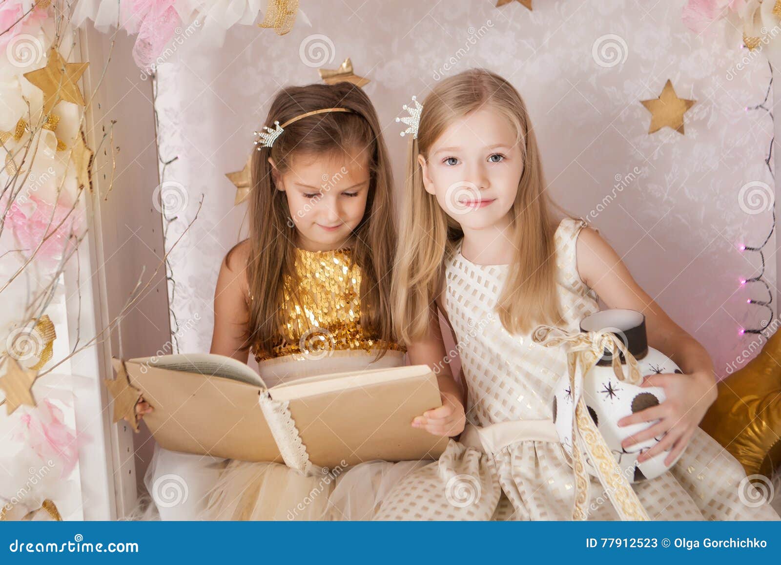 Two girls with a book stock image. Image of lights, merry - 77912523