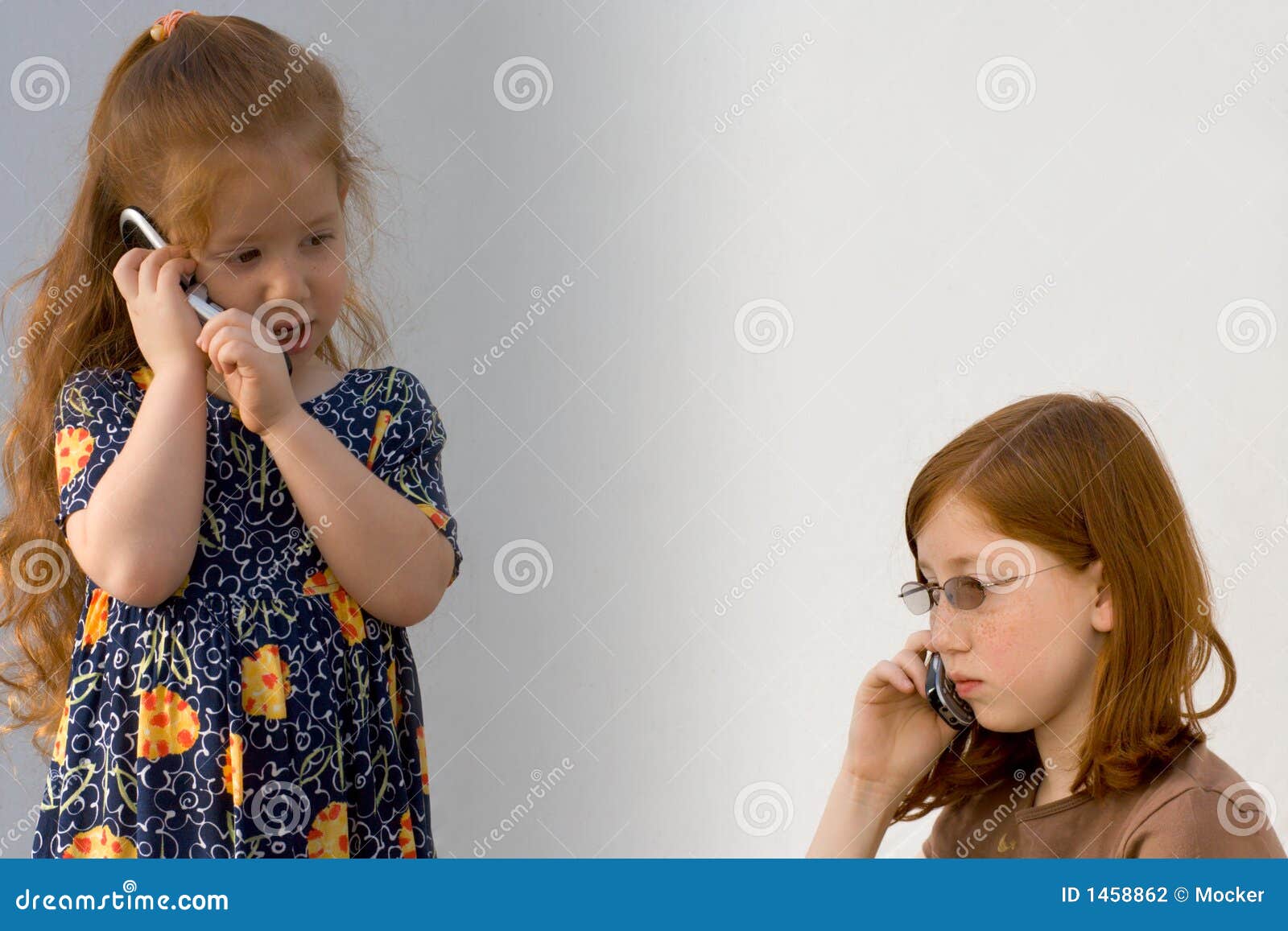 Two girls with cell phones stock photo. Image of cellular - 1458862