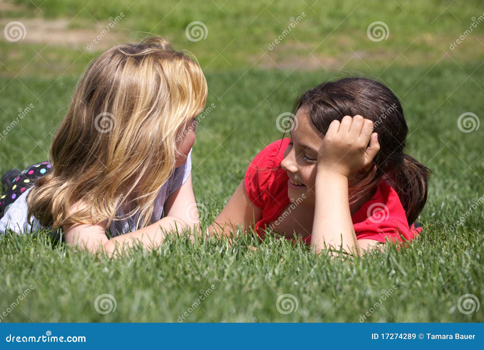 Two Girls Chatting in Grass Stock Image - Image of child, happy: 17274289