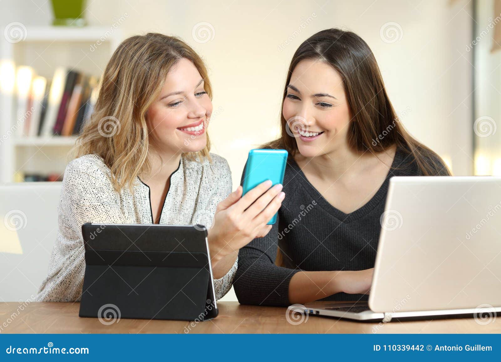 Two Girls Checking Information in Multiple Devices Stock Photo - Image ...