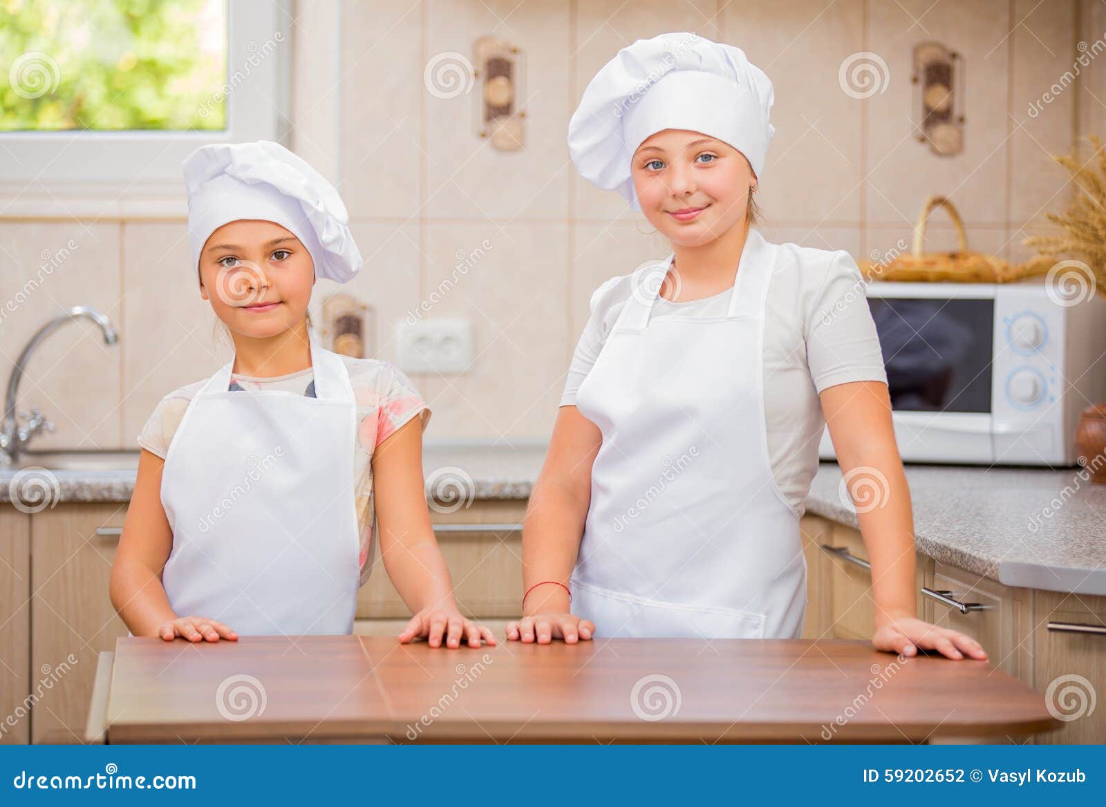 Two girls cook stock photo. Image of preparation, happy - 59202652