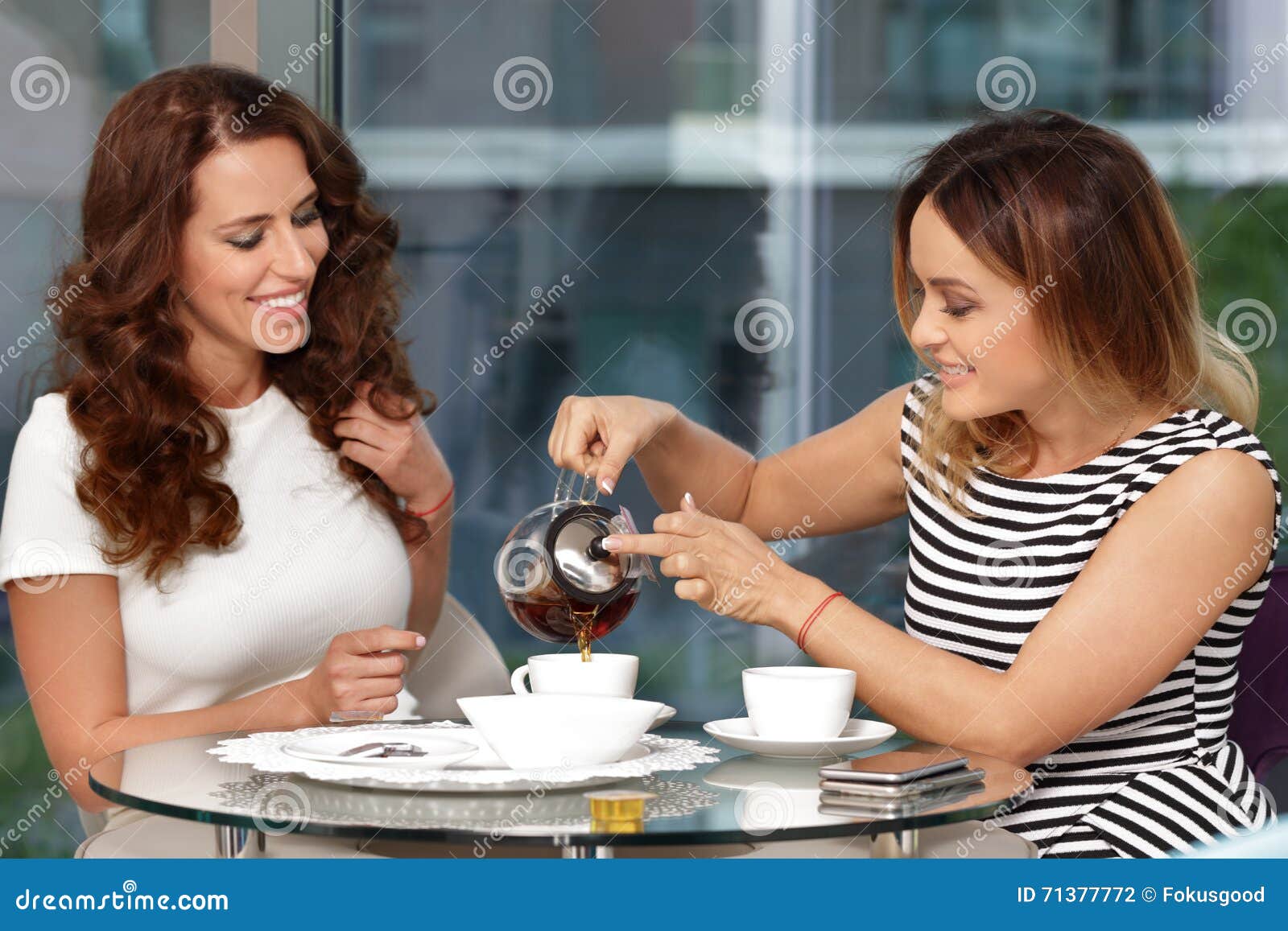 Two Girls Drink Tea in Cafe Stock Photo - Image of drink, communication ...