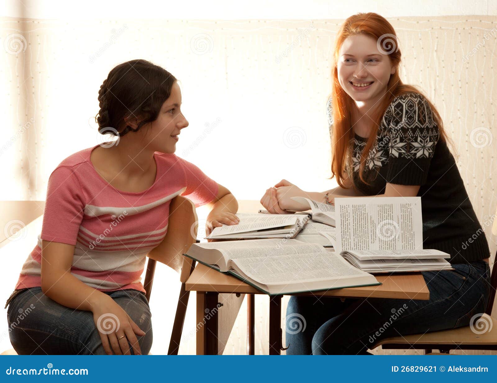 Two Girls Engage in a Library Stock Image - Image of read, learning ...