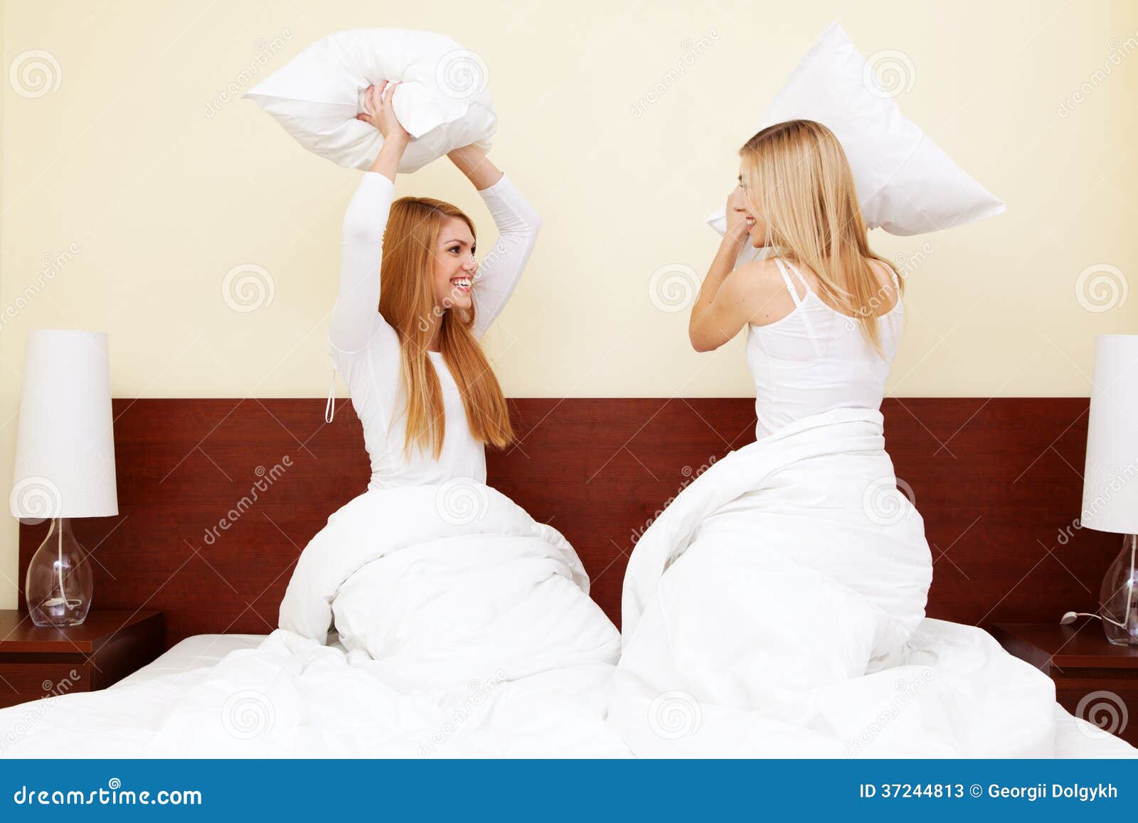 Two Girls Having a Pillow Fight in Bedroom Stock Image - Image of ...