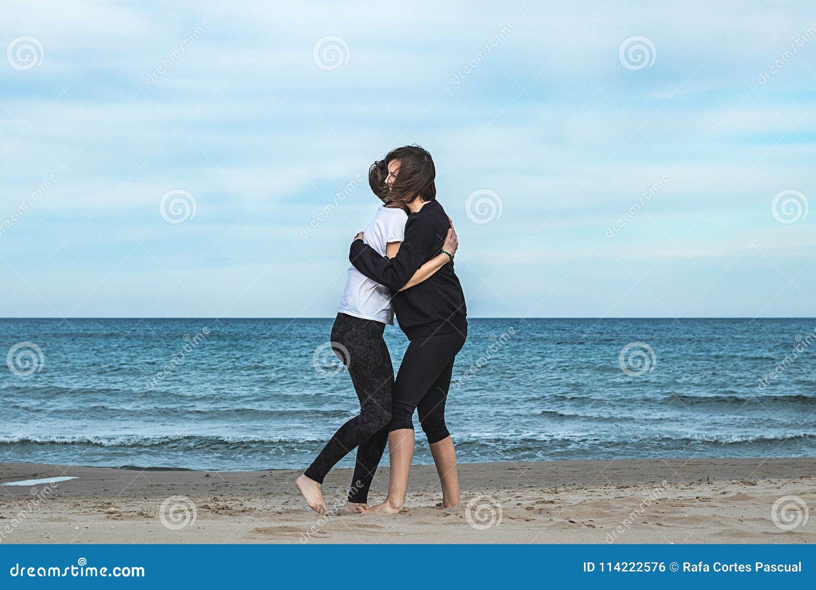 Two Girls Hugging on the Beach Stock Photo - Image of happy, healthy ...