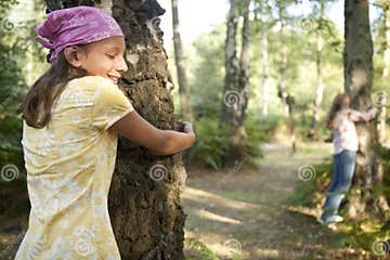 Two Girls Hugging Trees in Forest Stock Photo - Image of caucasian ...