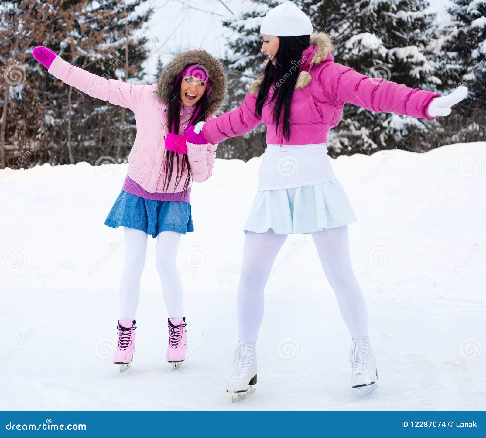 Two girls ice skating stock photo. Image of active, life - 12287074