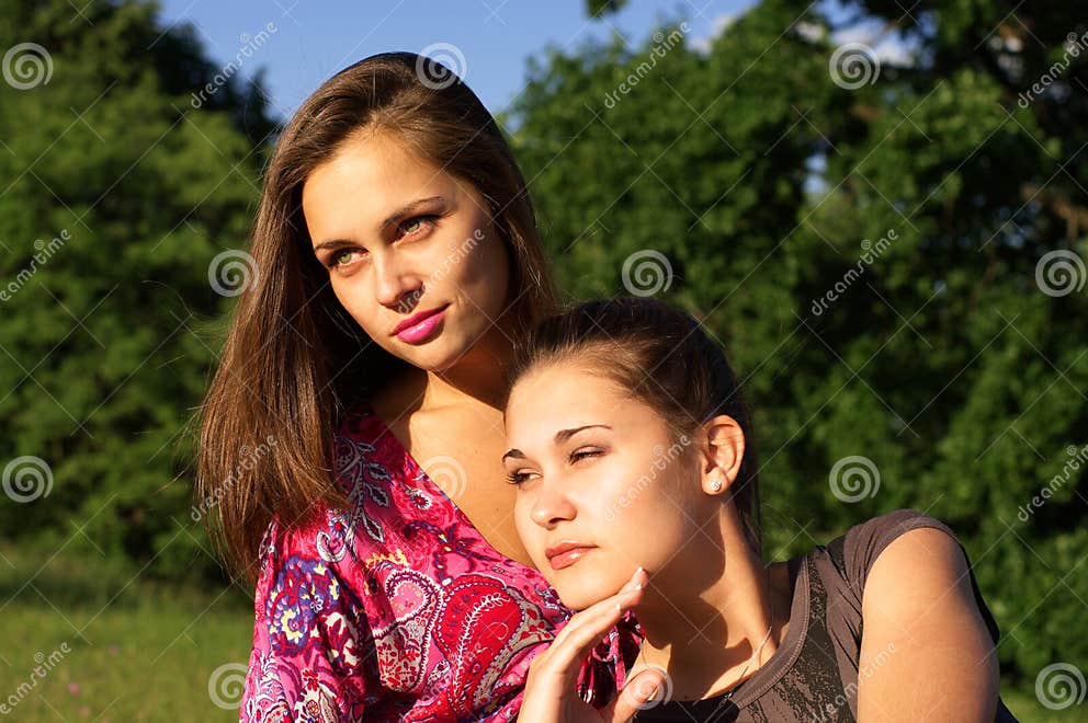 Two Girls Leaning in Sunset Light Stock Photo - Image of lean, enjoy ...
