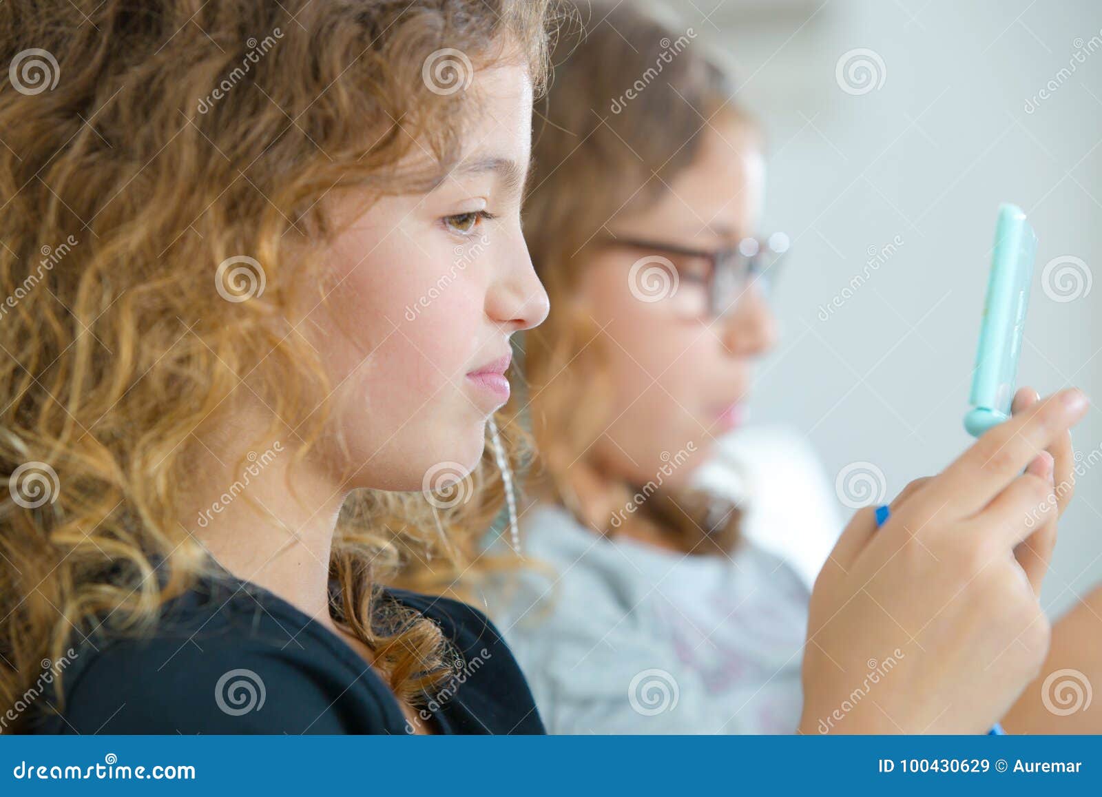 Two girls look on phone stock image. Image of adult - 100430629