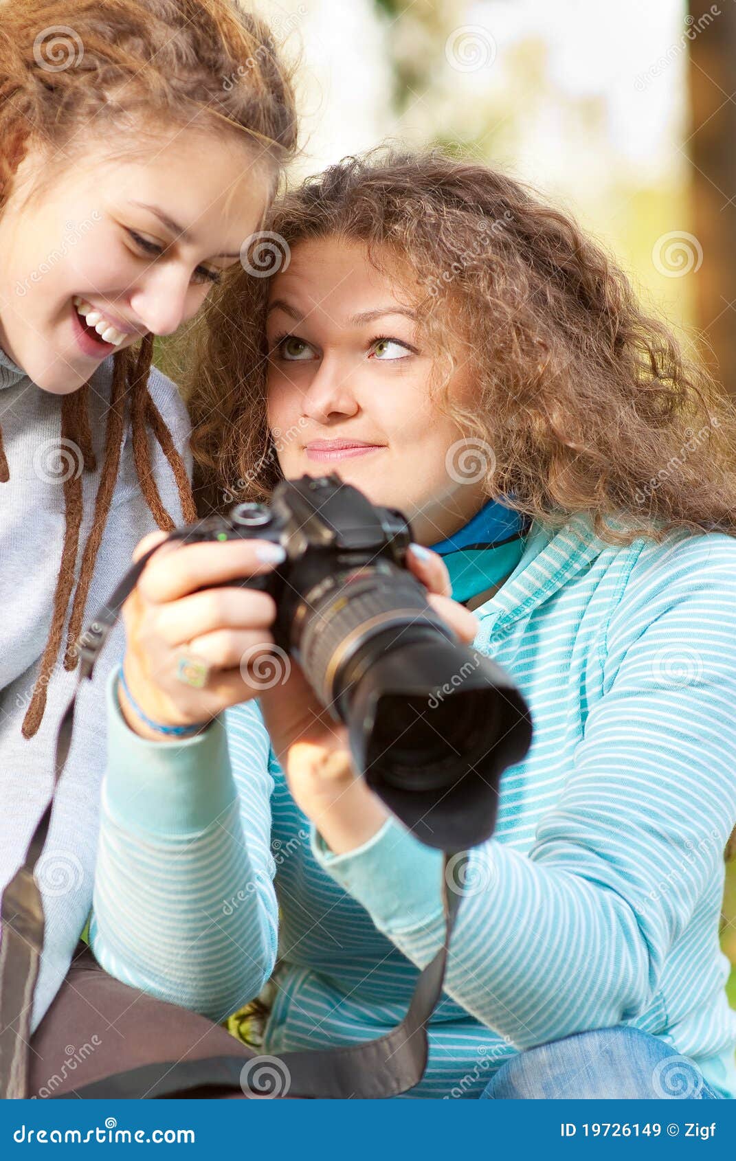 Two Girls Look through Pictures on Stock Image - Image of friends ...
