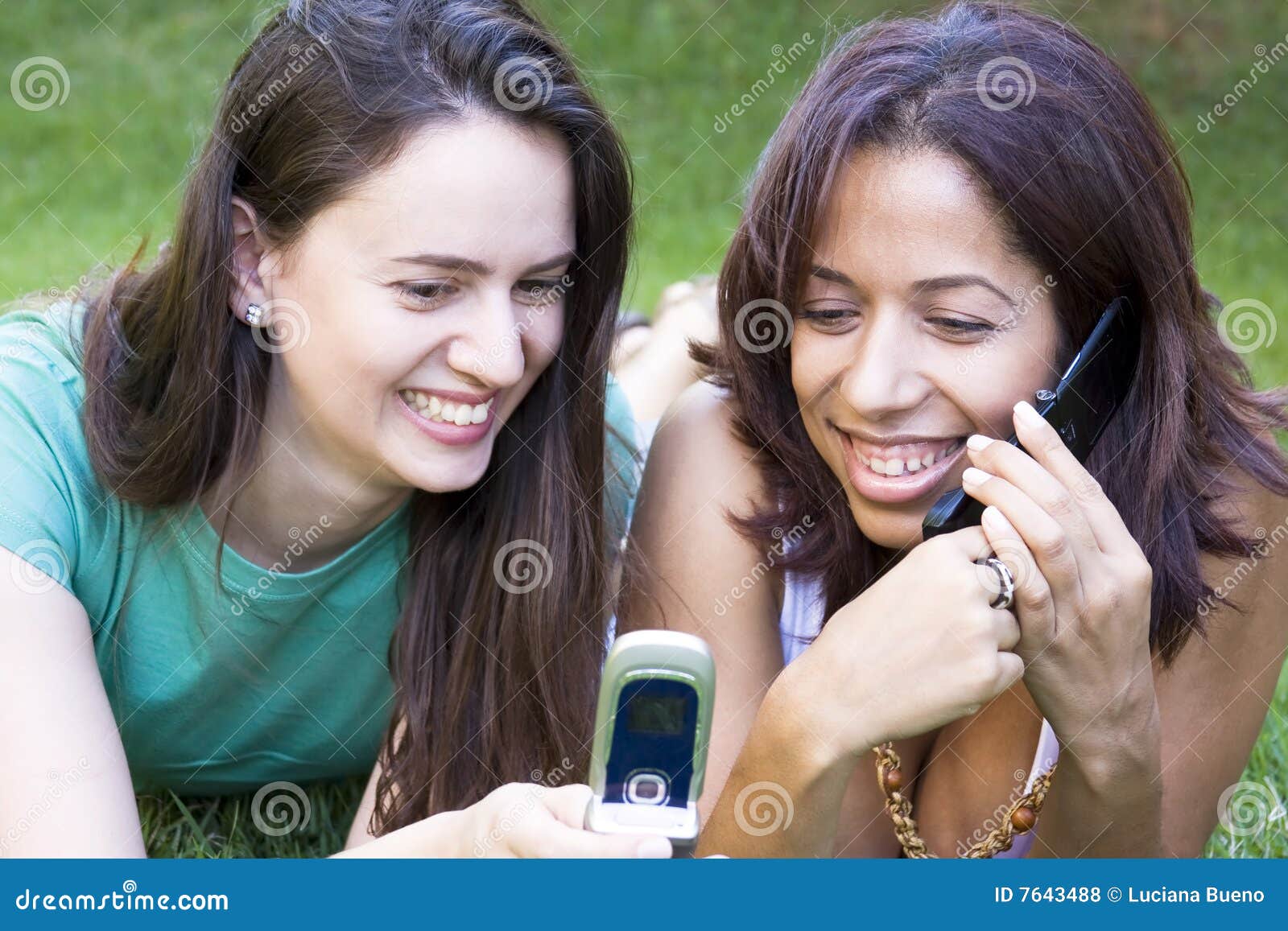 Two girls with phone stock photo. Image of happiness, lying - 7643488