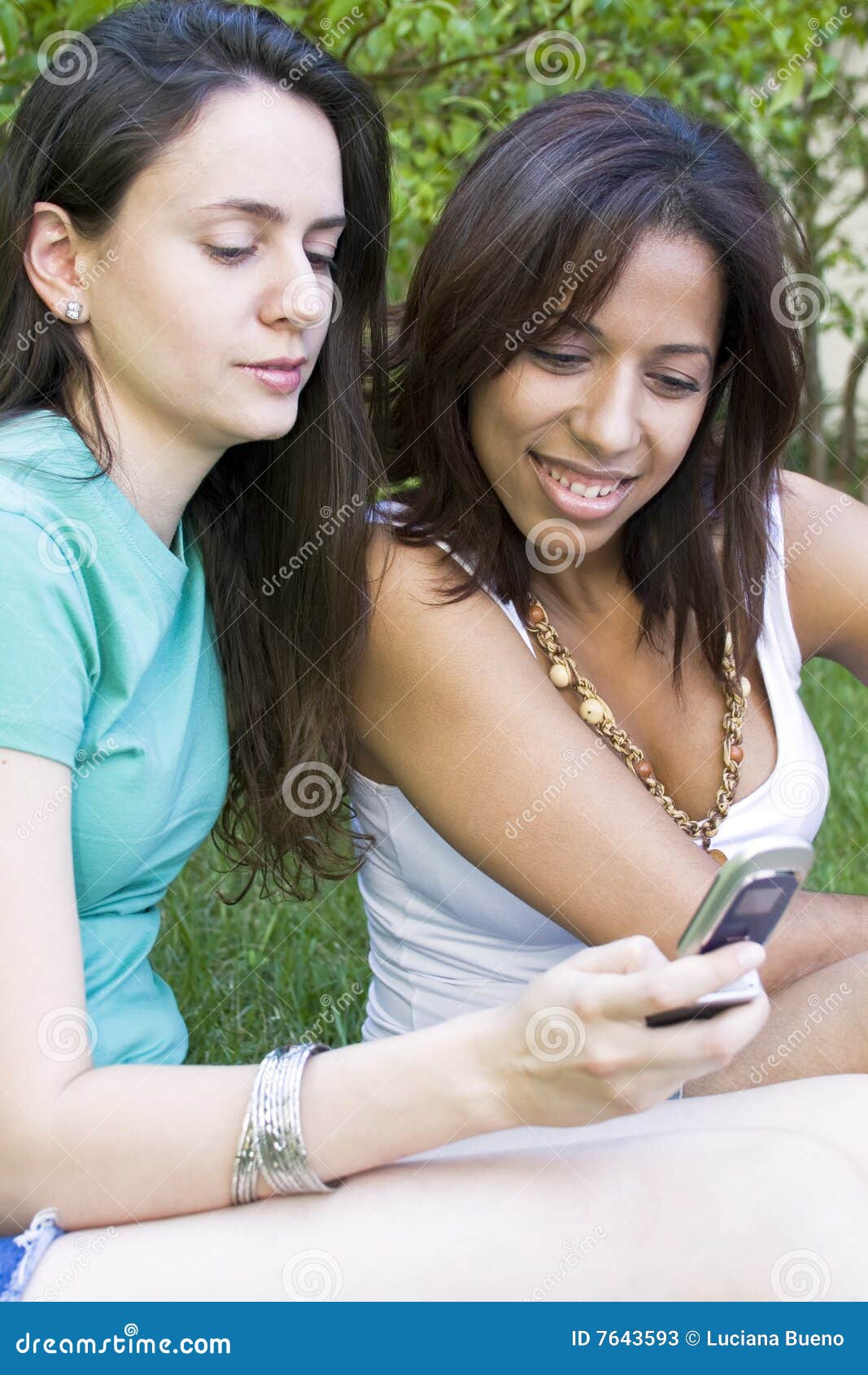 Two girls with phone stock image. Image of race, cheerful - 7643593