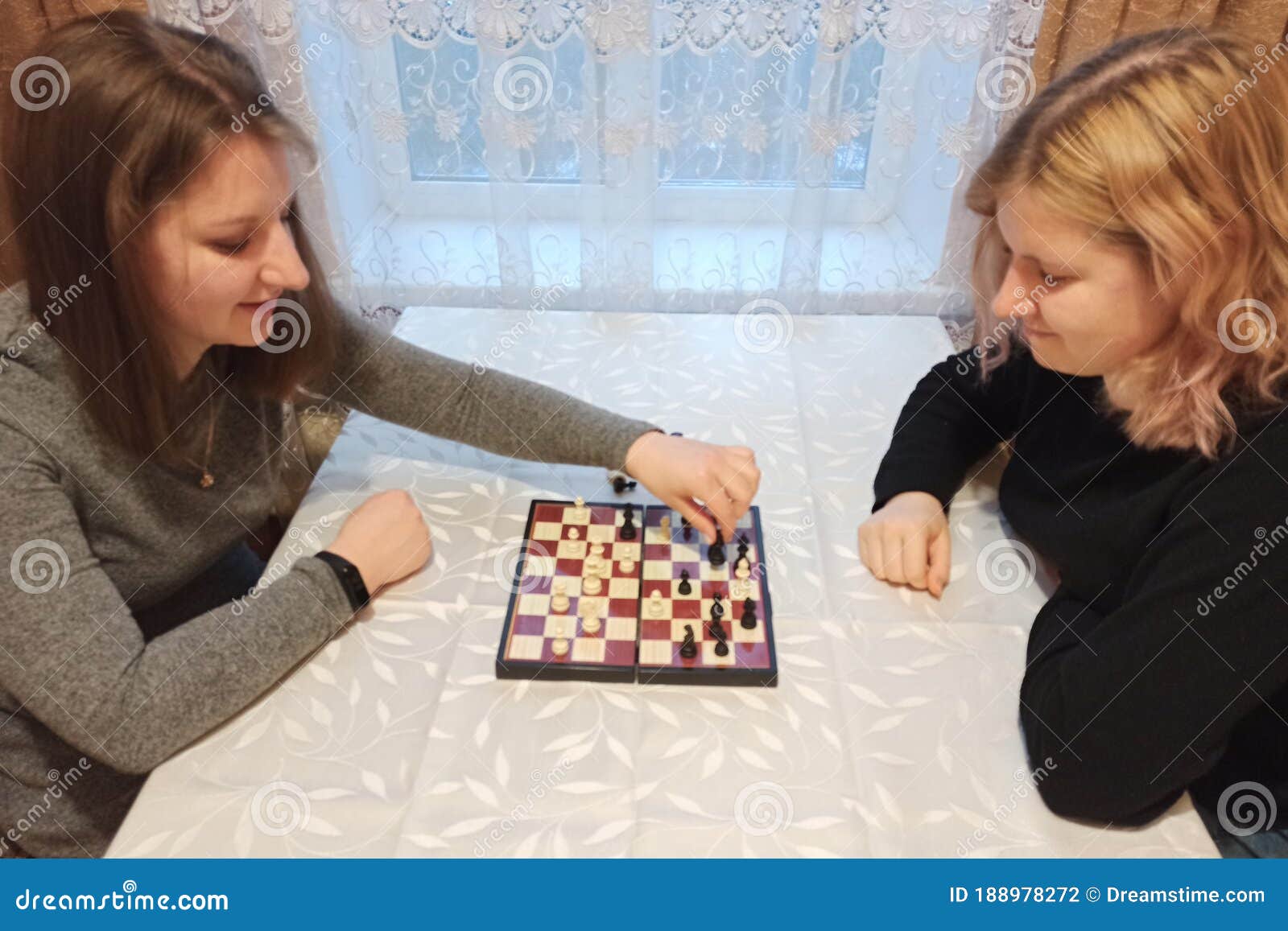 Girls play chess at table stock photo. Image of family - 188978272