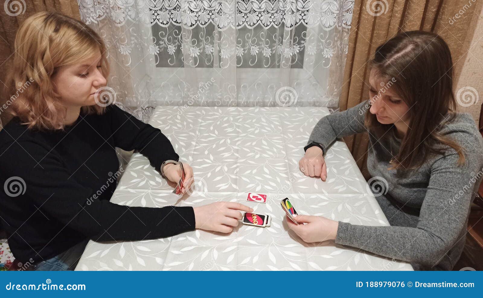 Girls Play Uno Cards at Table Editorial Photo - Image of excitement ...