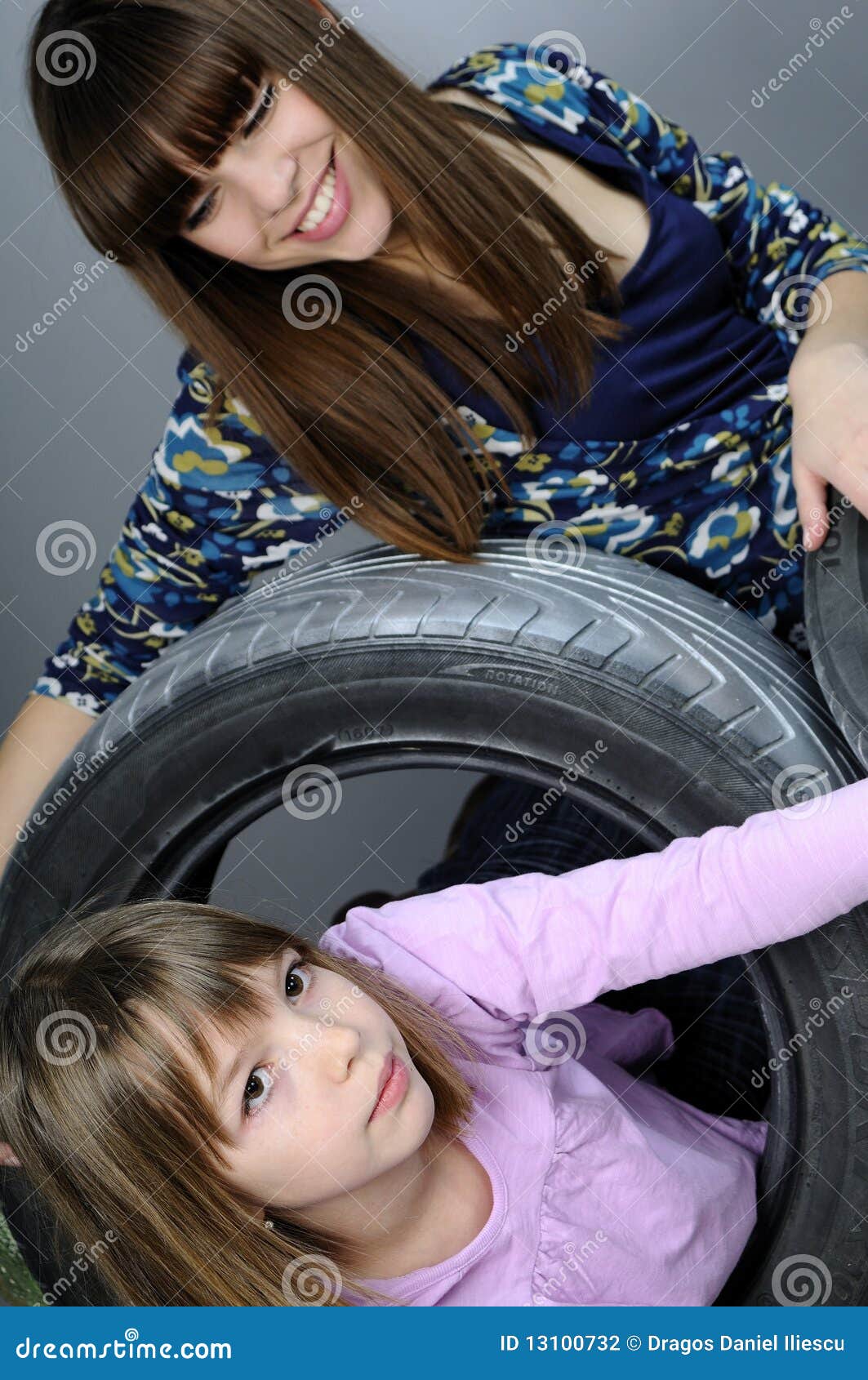 Two girls posing on tires stock photo. Image of boot - 13100732
