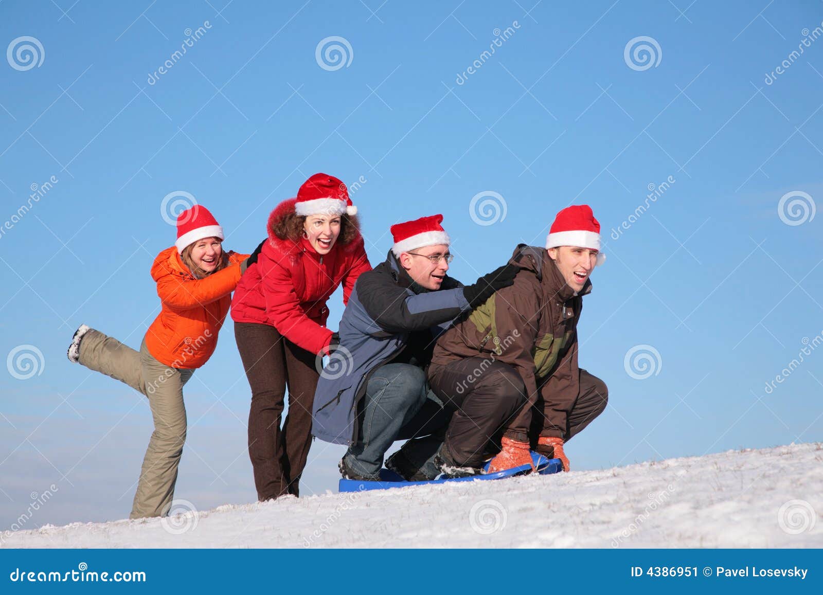 Two Girls Push Two Men on Sled Stock Image - Image of blue, frost: 4386951