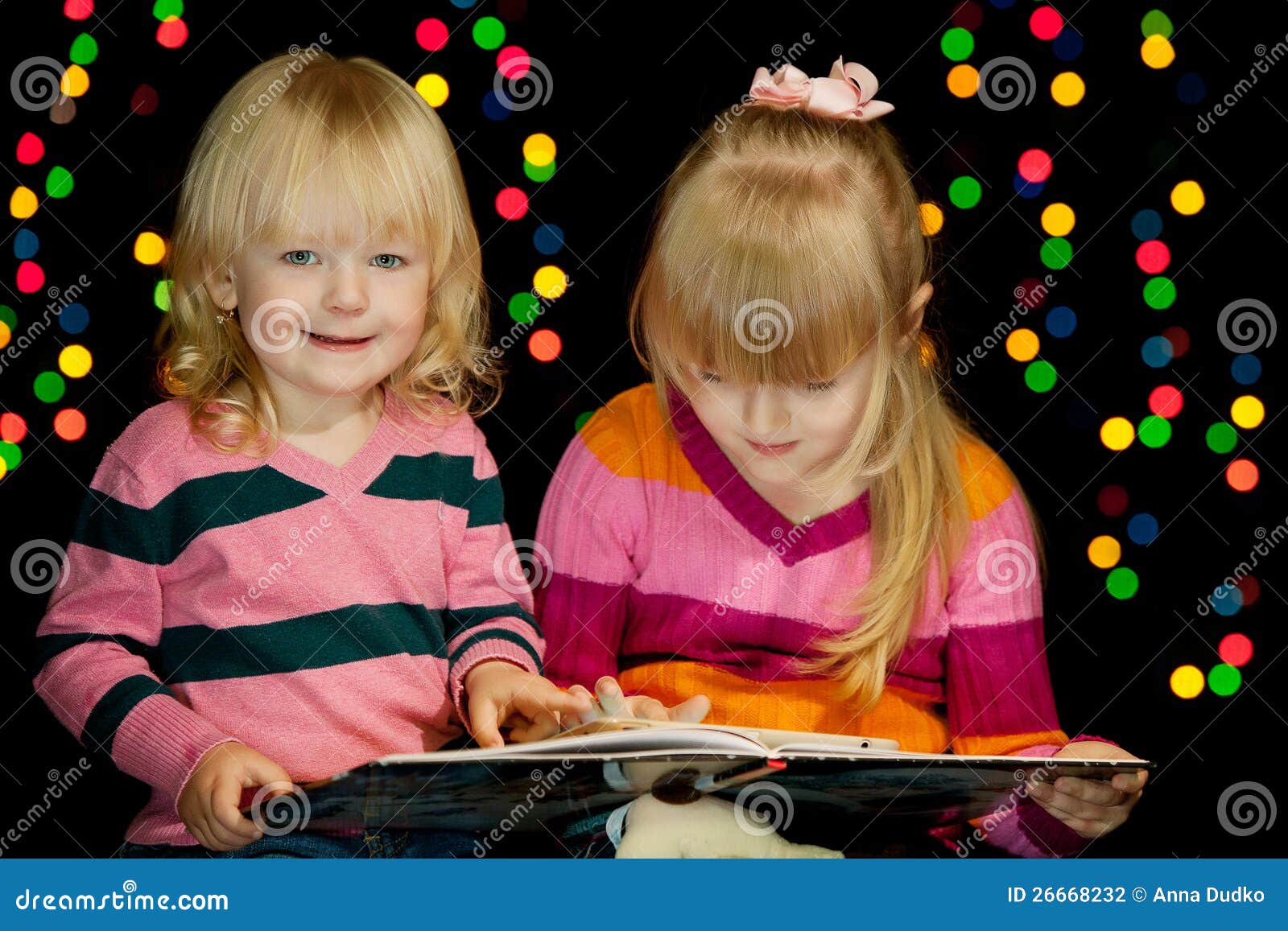 Two girls read book stock photo. Image of face, little - 26668232