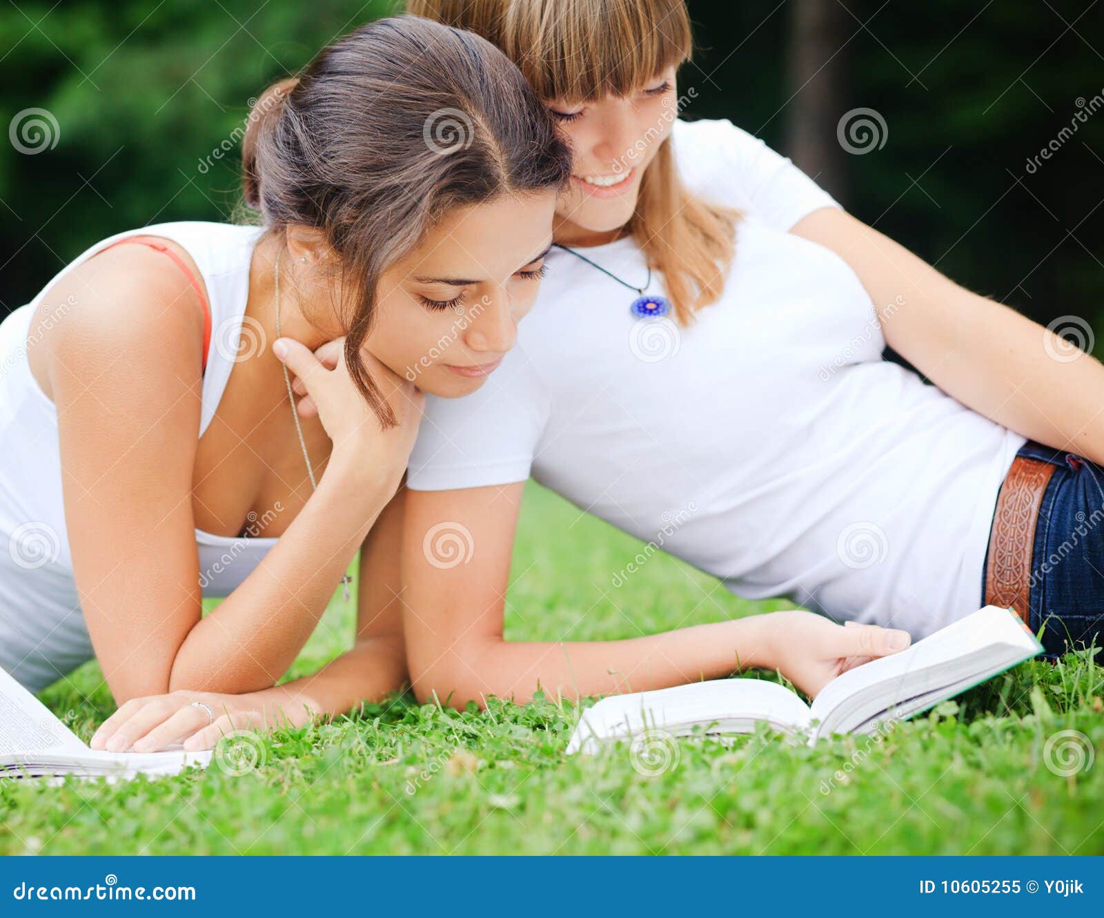 Two girls reading a book stock image. Image of face, grass - 10605255