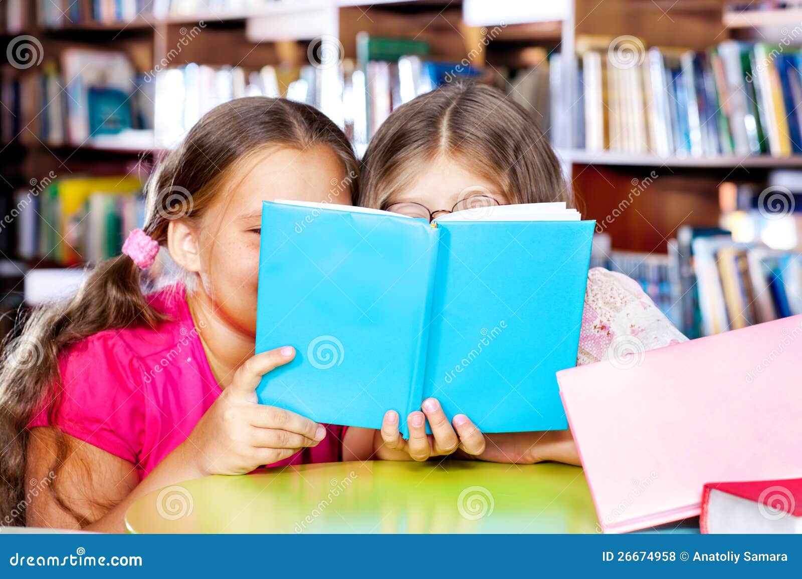 Two girls reading a book stock photo. Image of cute, busy - 26674958