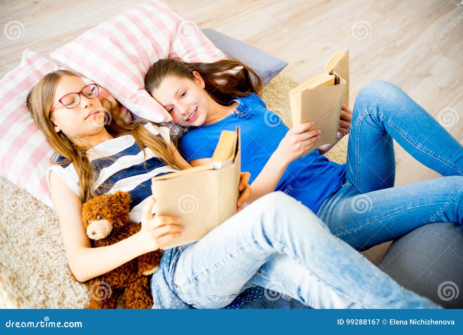 Two girls reading books stock image. Image of friendship - 99288167