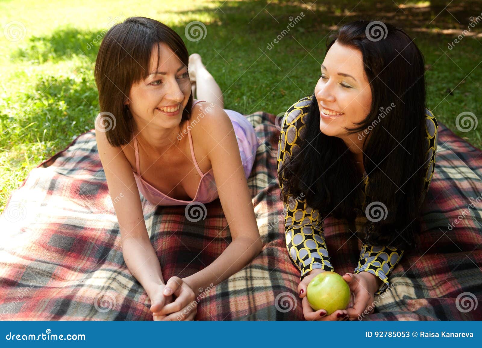 Two girls relaxing in park stock image. Image of athletic - 92785053