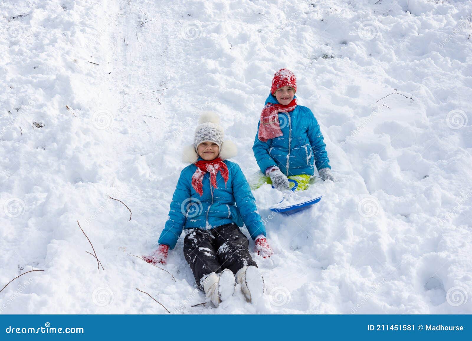 Two Girls Rolled Down the Hill and Sitting in the Snow Joyfully Look ...