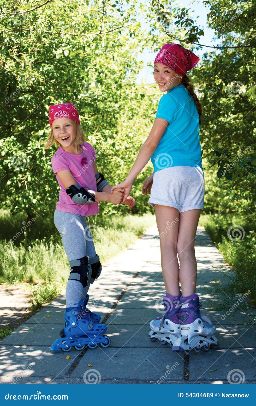 Two Girls in Roller Skates Looking at the Camera. Stock Image - Image ...