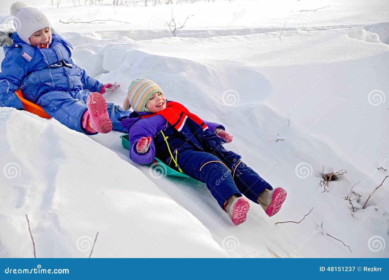 Two Girls Rolling Down a Hill in Snow Stock Image - Image of cheerful ...