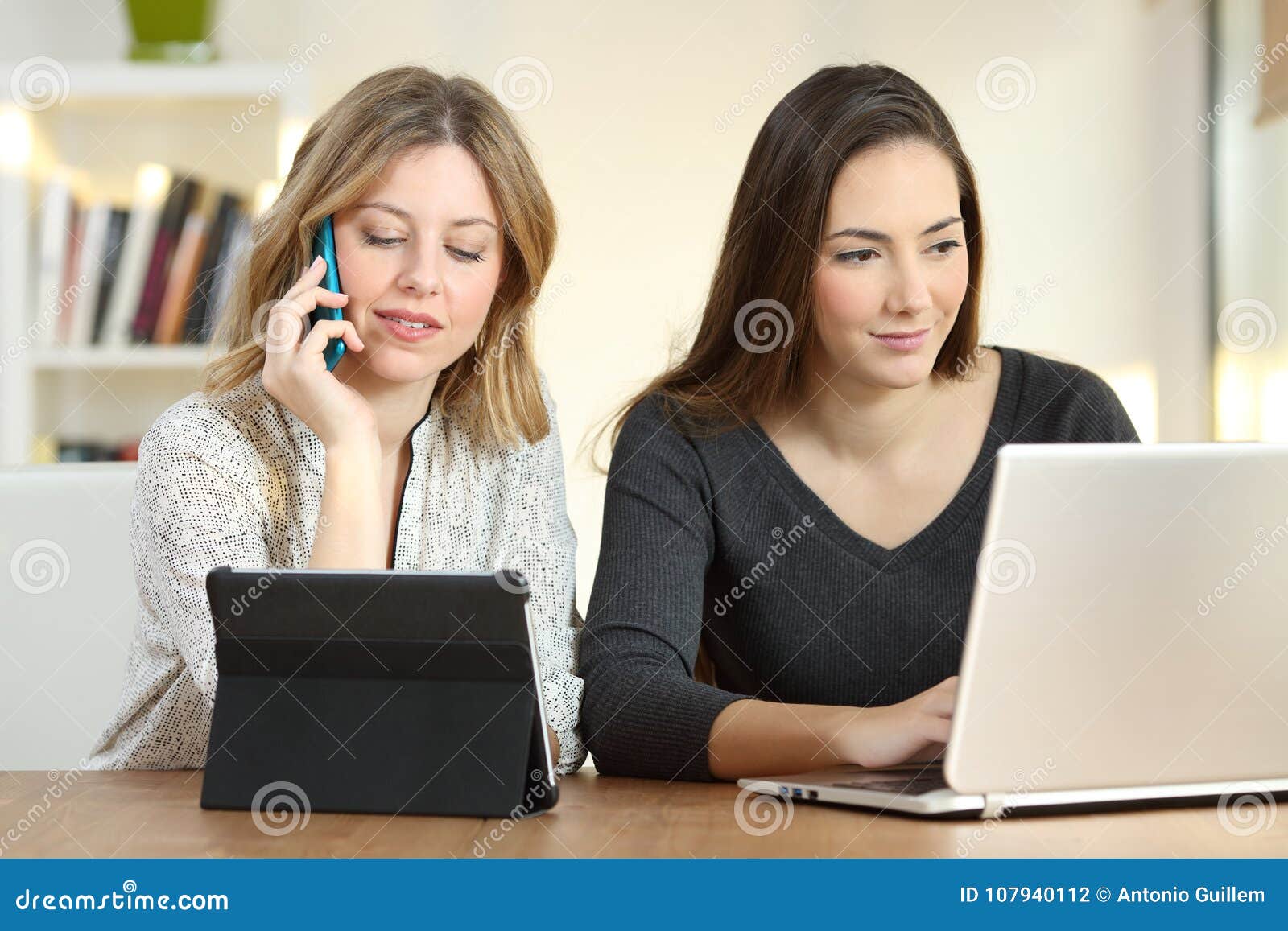 Two Girls Searching Content Using Multiple Devices Stock Photo - Image ...