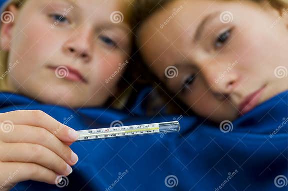 Two girls sick in bed stock image. Image of fever, influence - 10559931