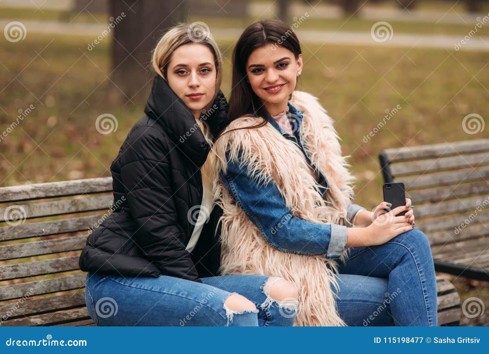 Two Girls Sitting On The Bench Outdoors Stock Image Image Of