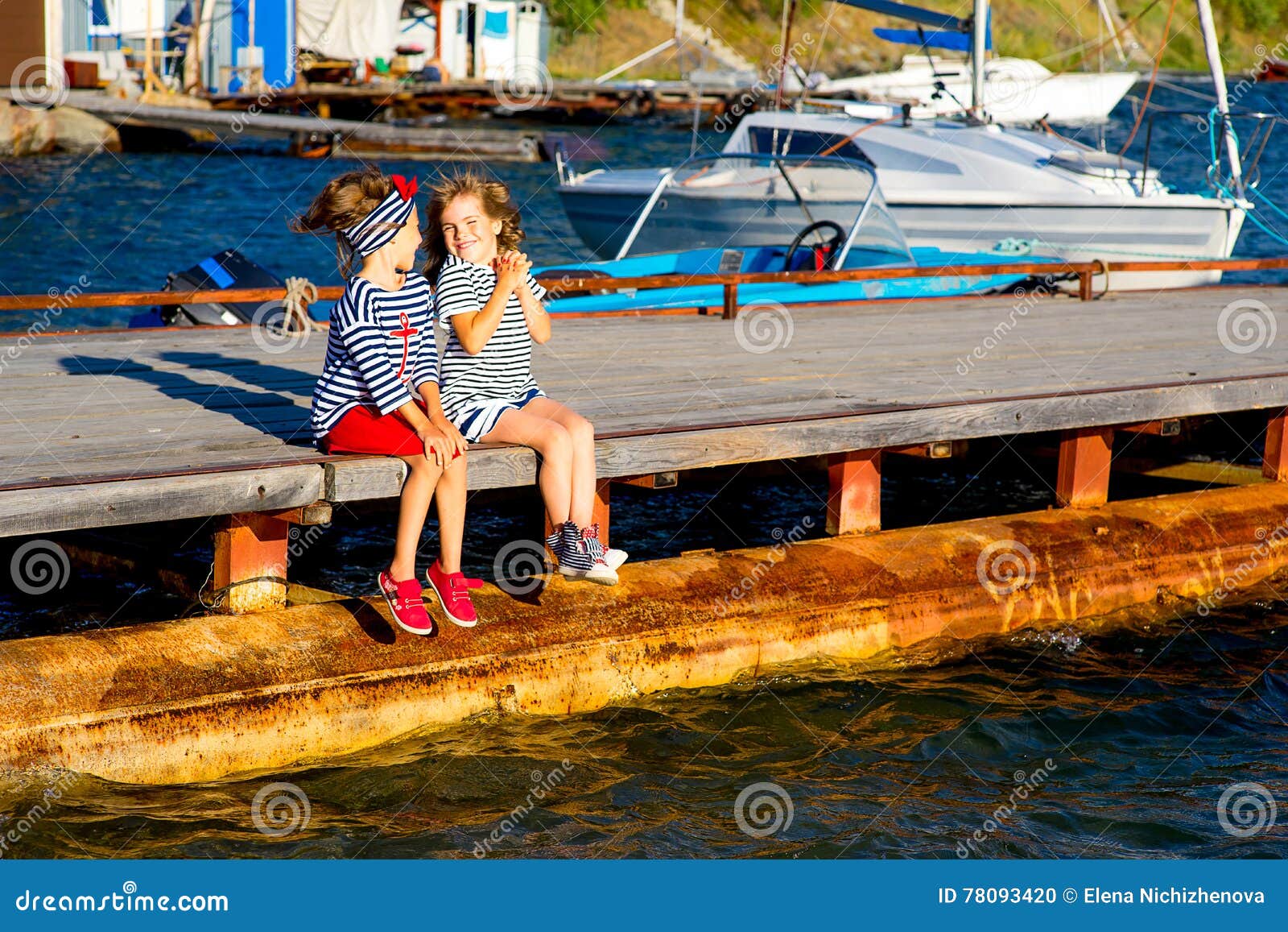 Two Girls Sitting on the Dock Stock Photo - Image of outdoors, anchor ...