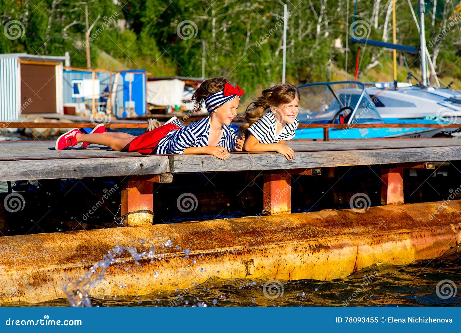 Two Girls Sitting on the Dock Stock Image - Image of attractive, laugh ...