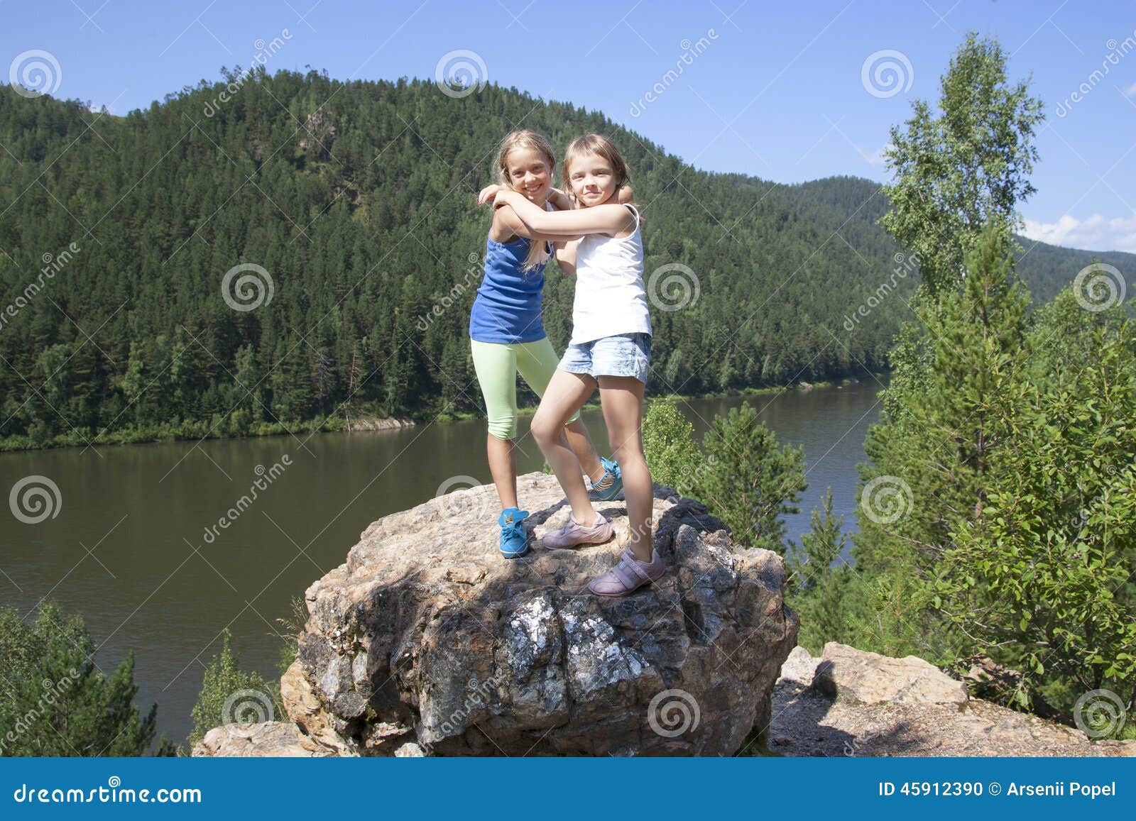 Two Girls Standing on a Rock and Enjoying River Stock Photo - Image of ...