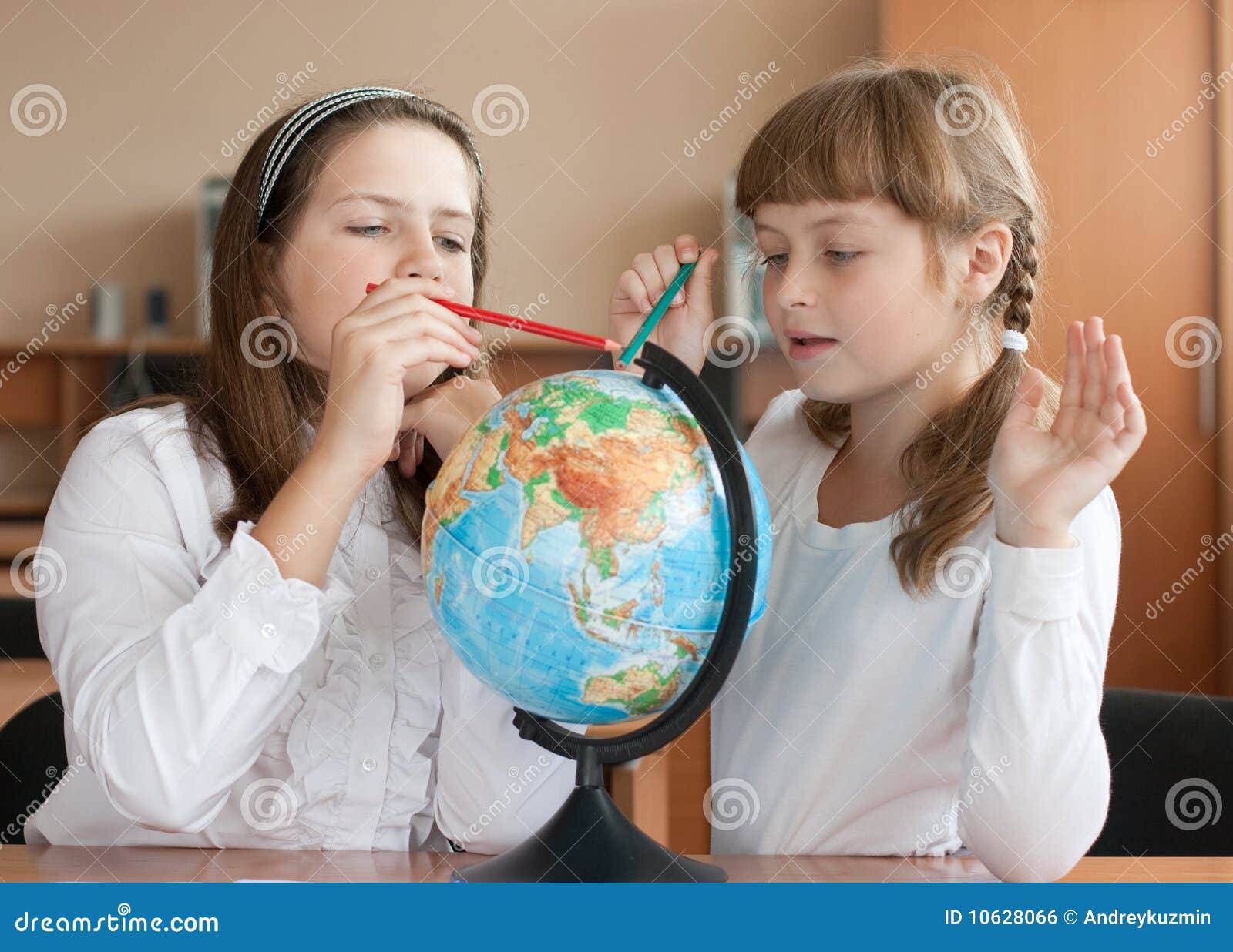 Two Girls Study Geography Using Globe Stock Photo - Image of pencil ...