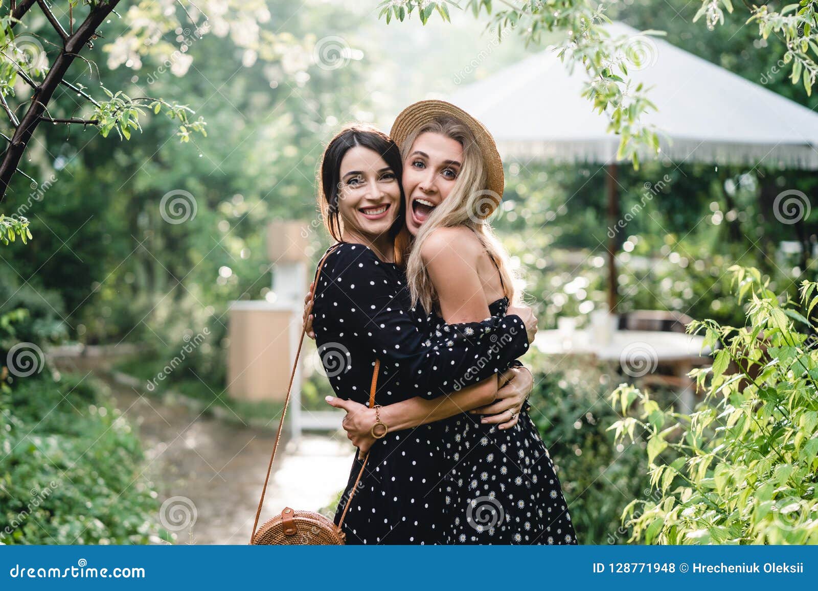 Two girls in a summer park stock photo. Image of laughter - 128771948
