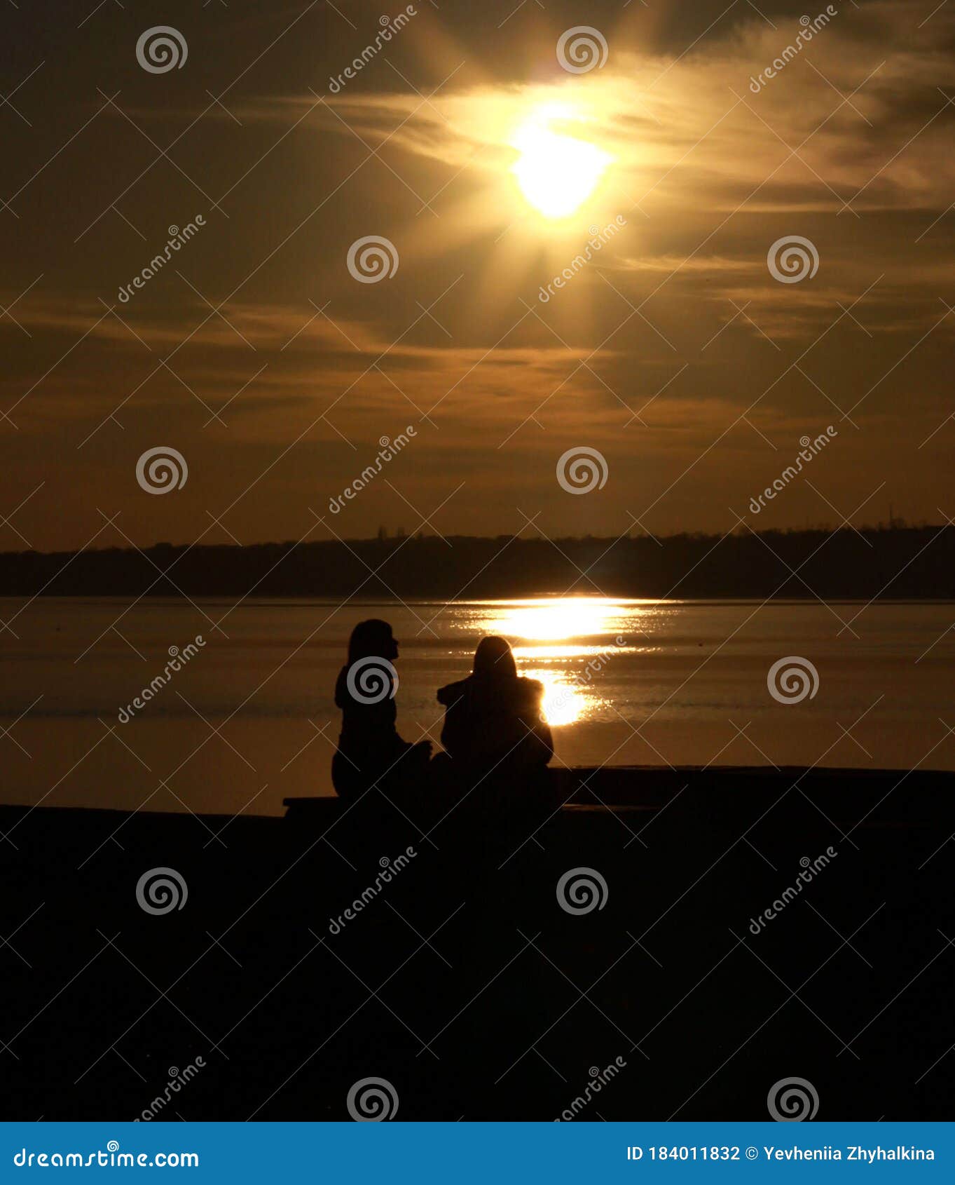 Two Girls in the Sunset Near the River Stock Photo - Image of shores ...