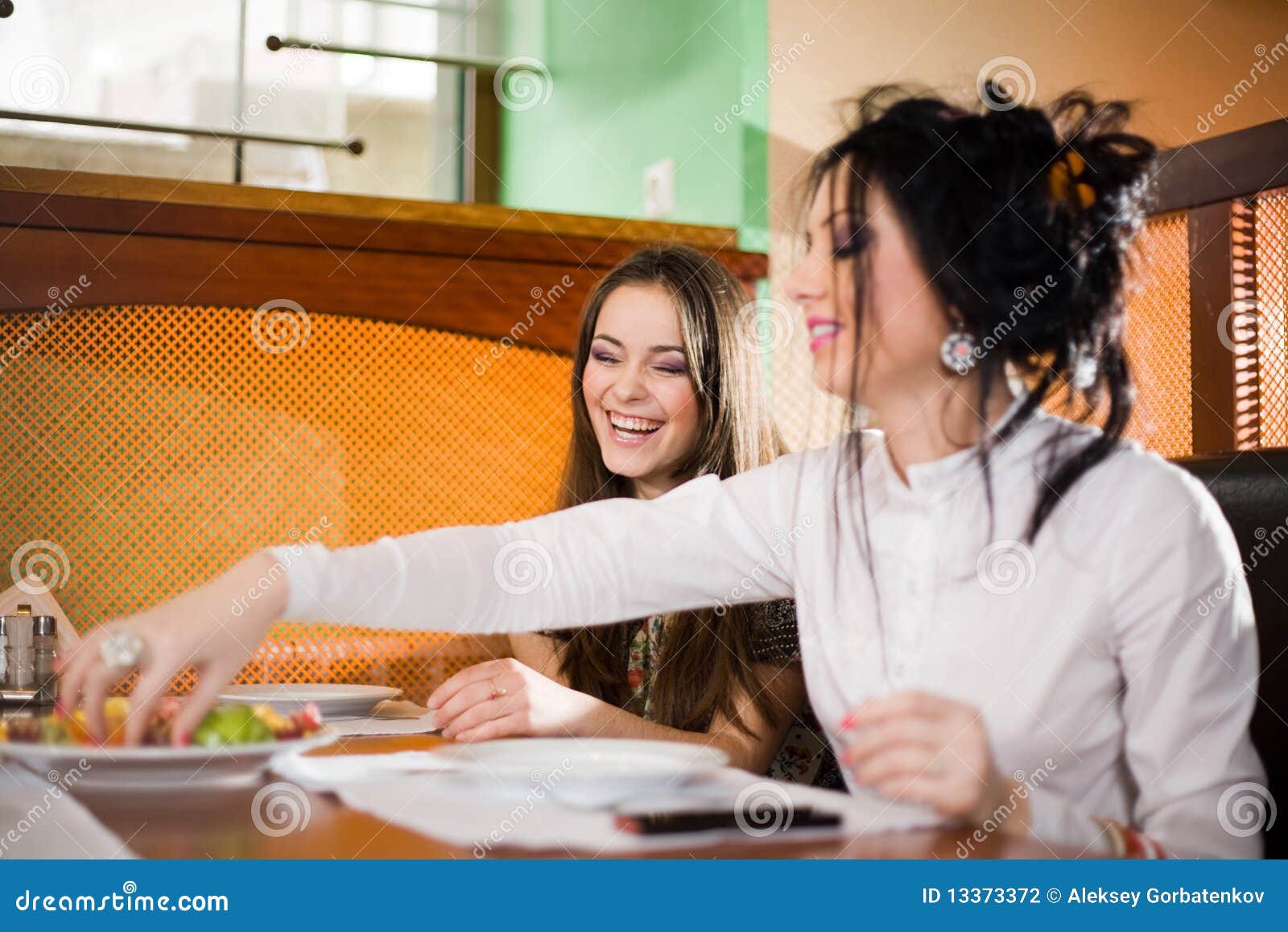 Two girls at table stock photo. Image of napkin, female - 13373372