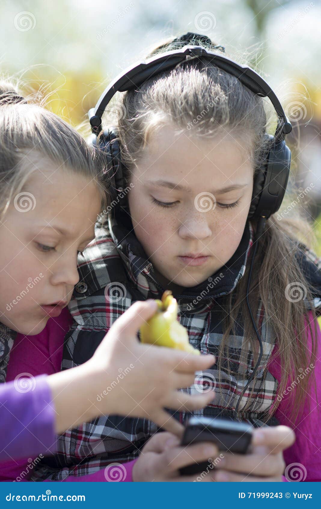 Two girls texting stock image. Image of children, serious - 71999243