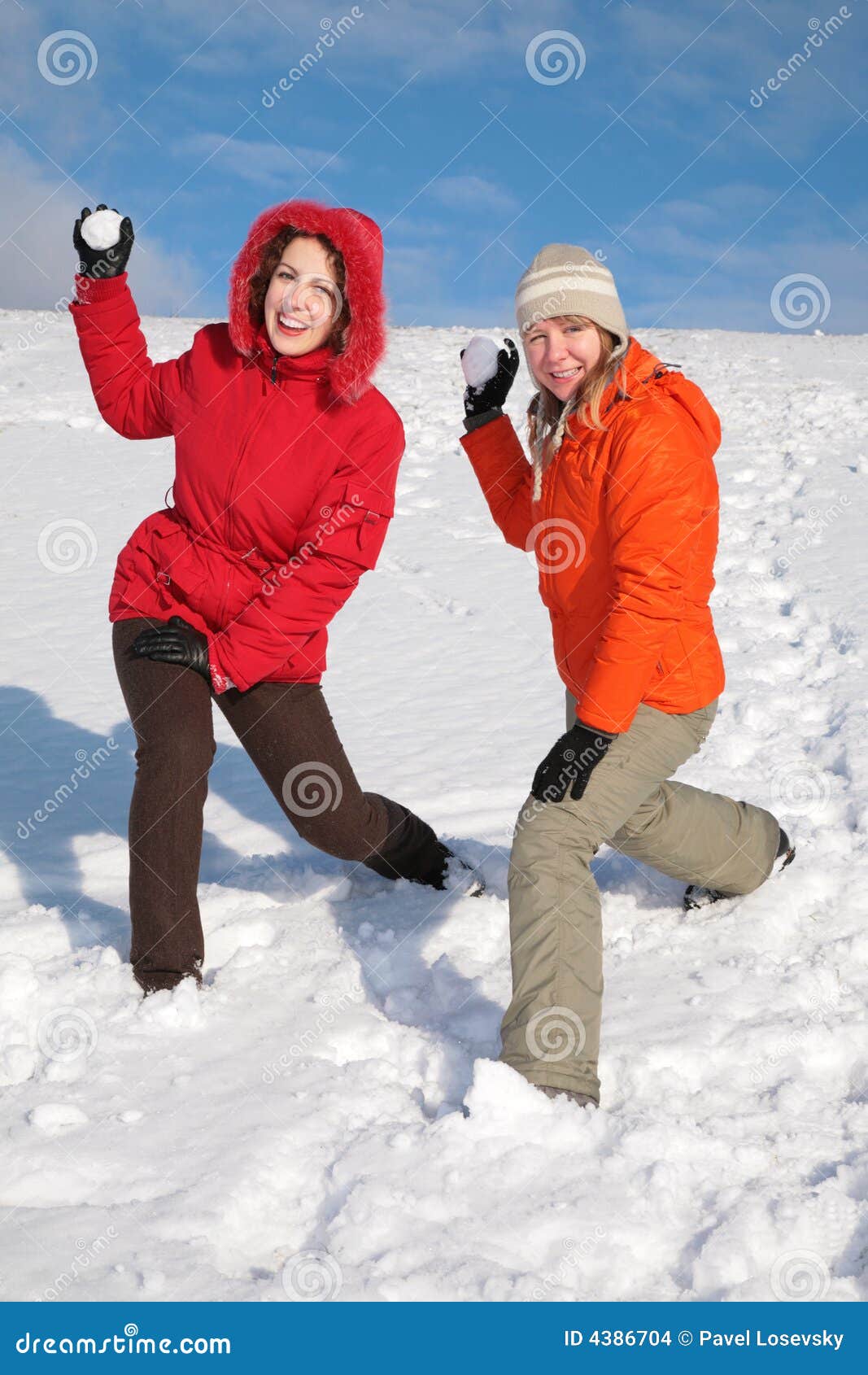 Two girls throw snowballs stock photo. Image of glove - 4386704
