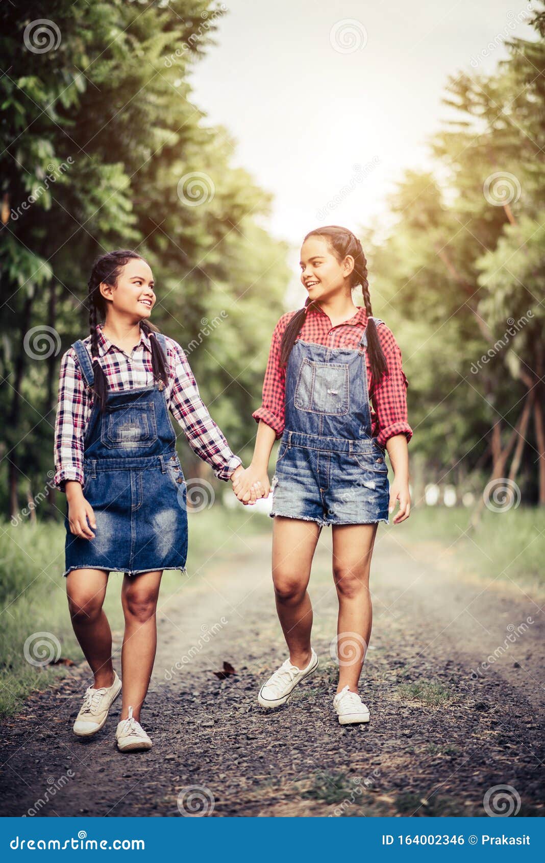 Two Girls Walking Along a Forest Stock Photo - Image of outdoor, park ...