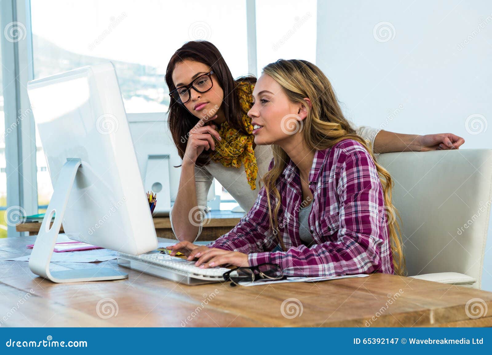 Two girls work at office stock image. Image of friendly - 65392147