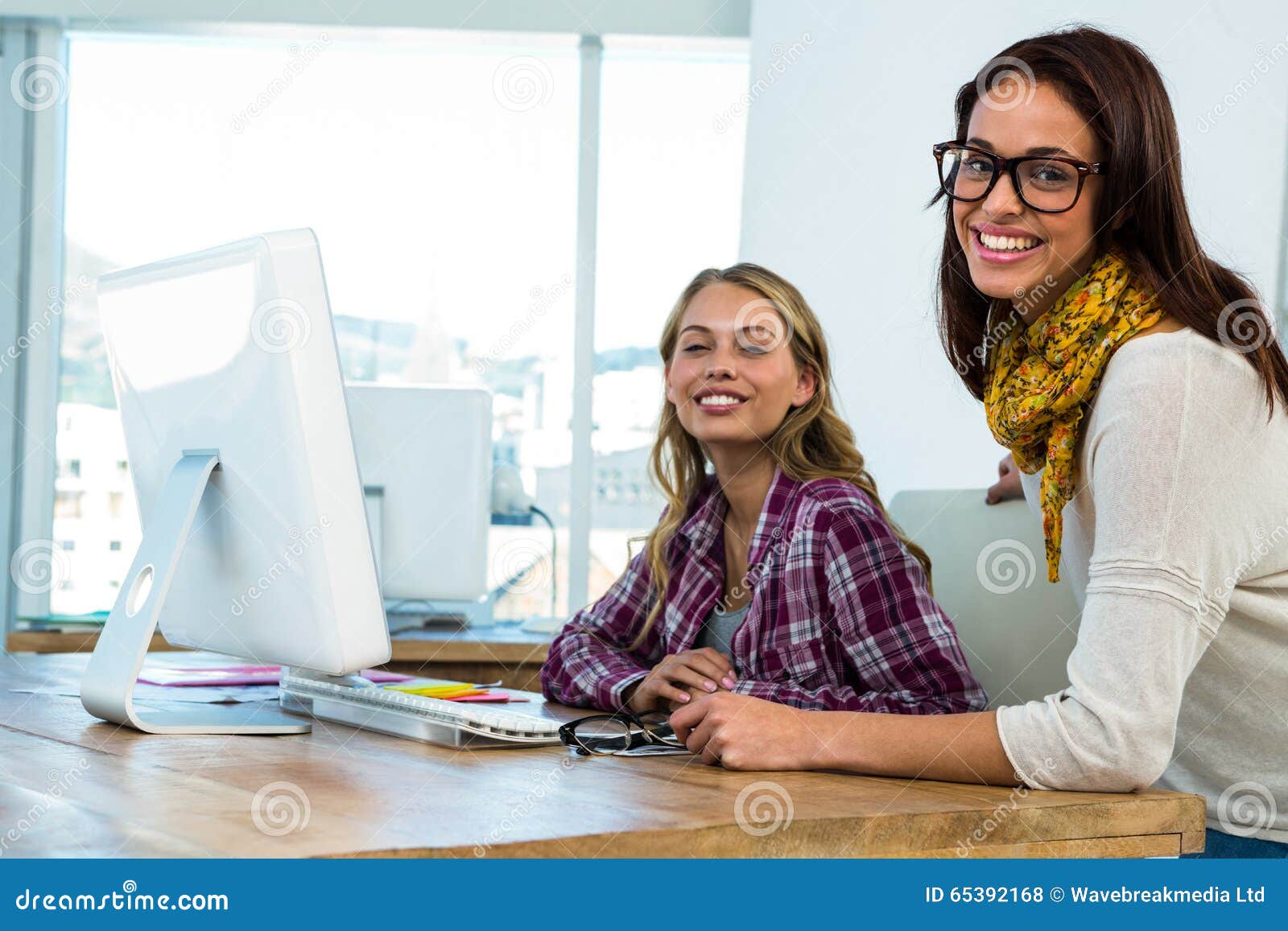 Two girls work at office stock photo. Image of casual - 65392168