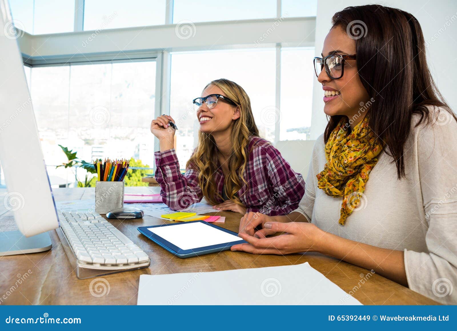 Two girls work at office stock image. Image of focused - 65392449