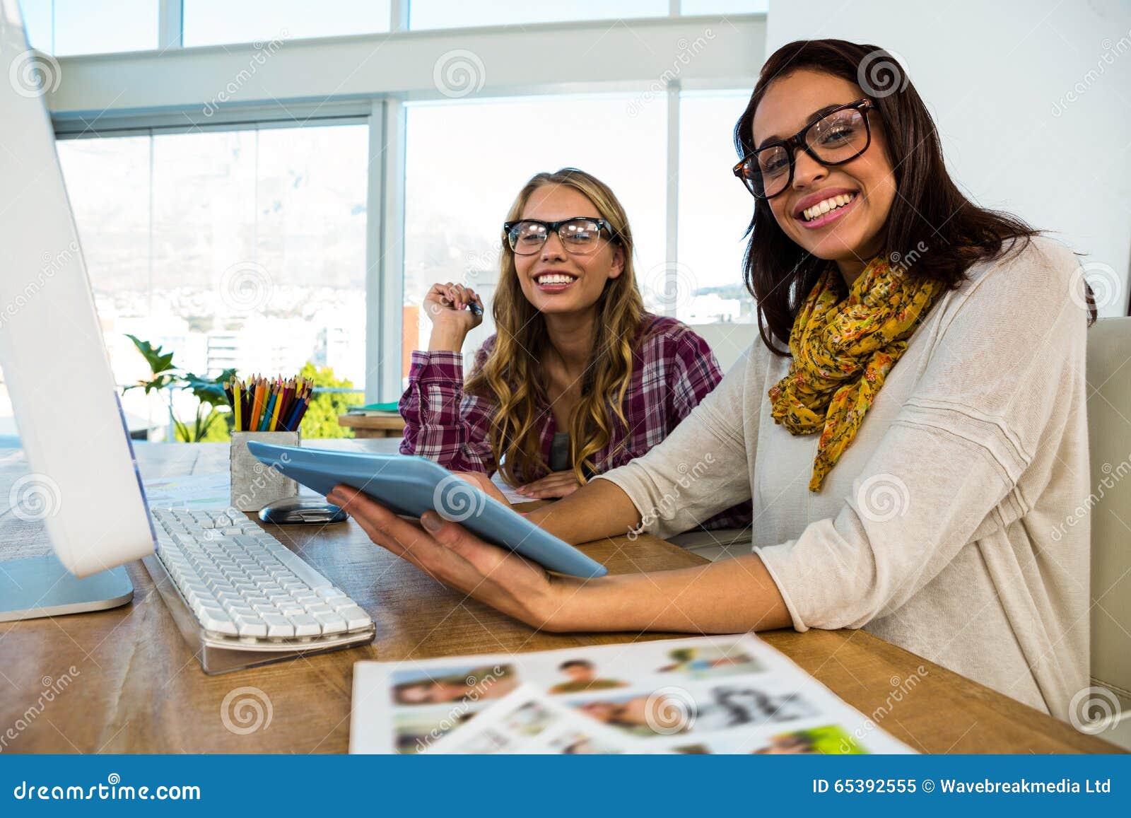 Two girls work at office stock image. Image of glasses - 65392555
