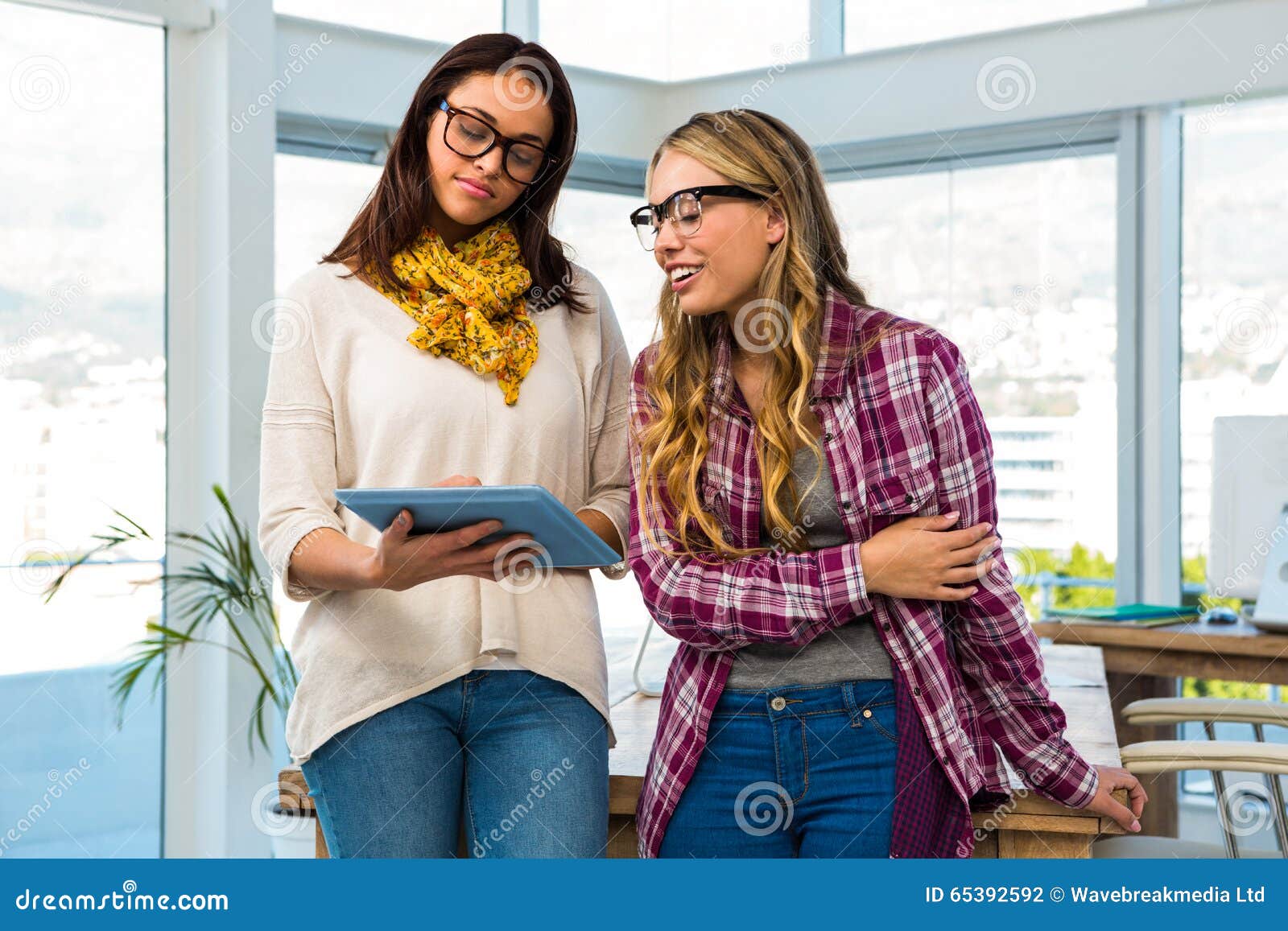 Two girls work at office stock photo. Image of attentively - 65392592