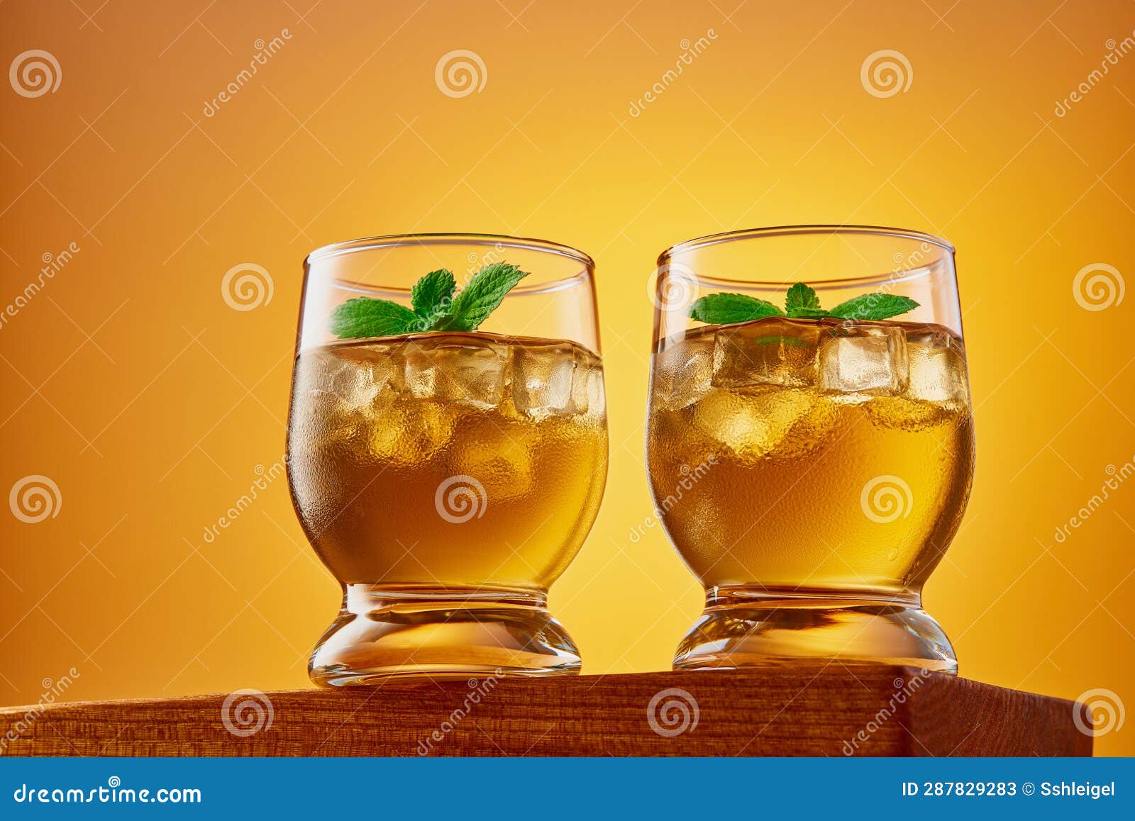 Two Glass of Refreshing Iced Tea with Ice Cubes and Mint Leaves. Studio ...