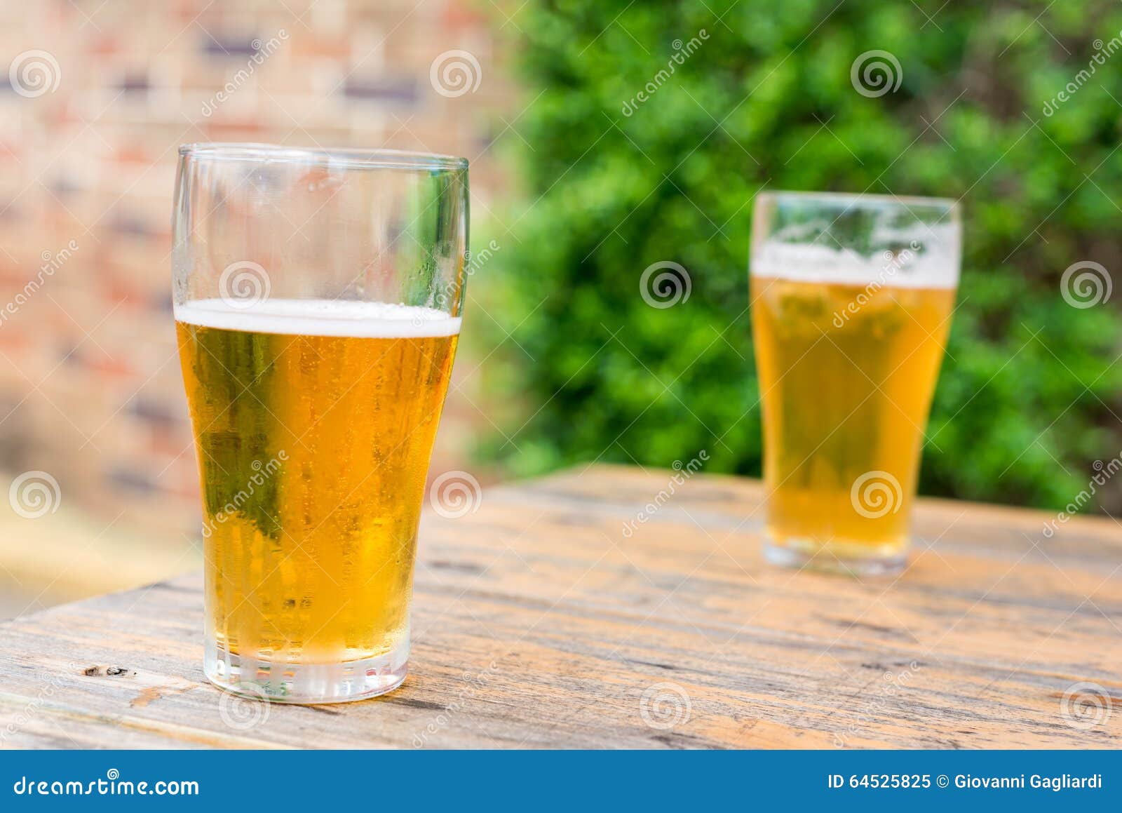 Two Glasses of Beer on a Table Outdoor Stock Image - Image of light ...